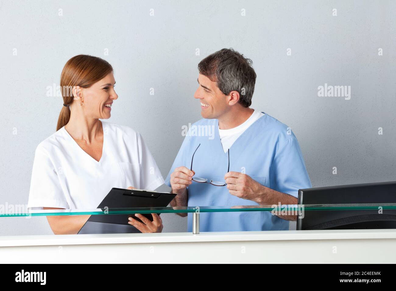 Laughing doctor and nurse with clipboard in the office Stock Photo - Alamy