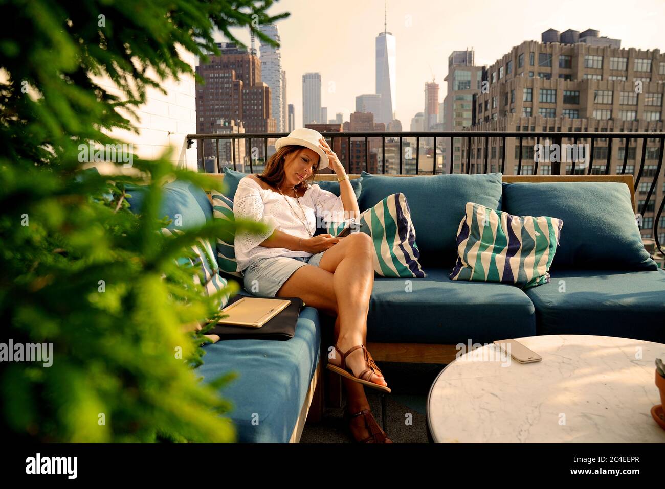 Woman relaxing on roof top hi-res stock photography and images - Alamy