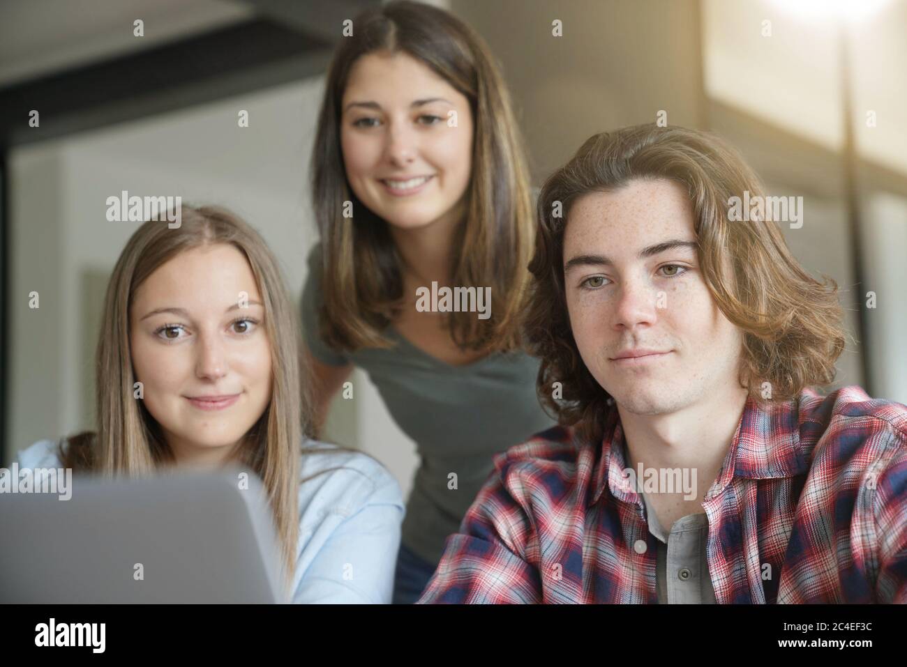 group of young people working on a laptop Stock Photo - Alamy