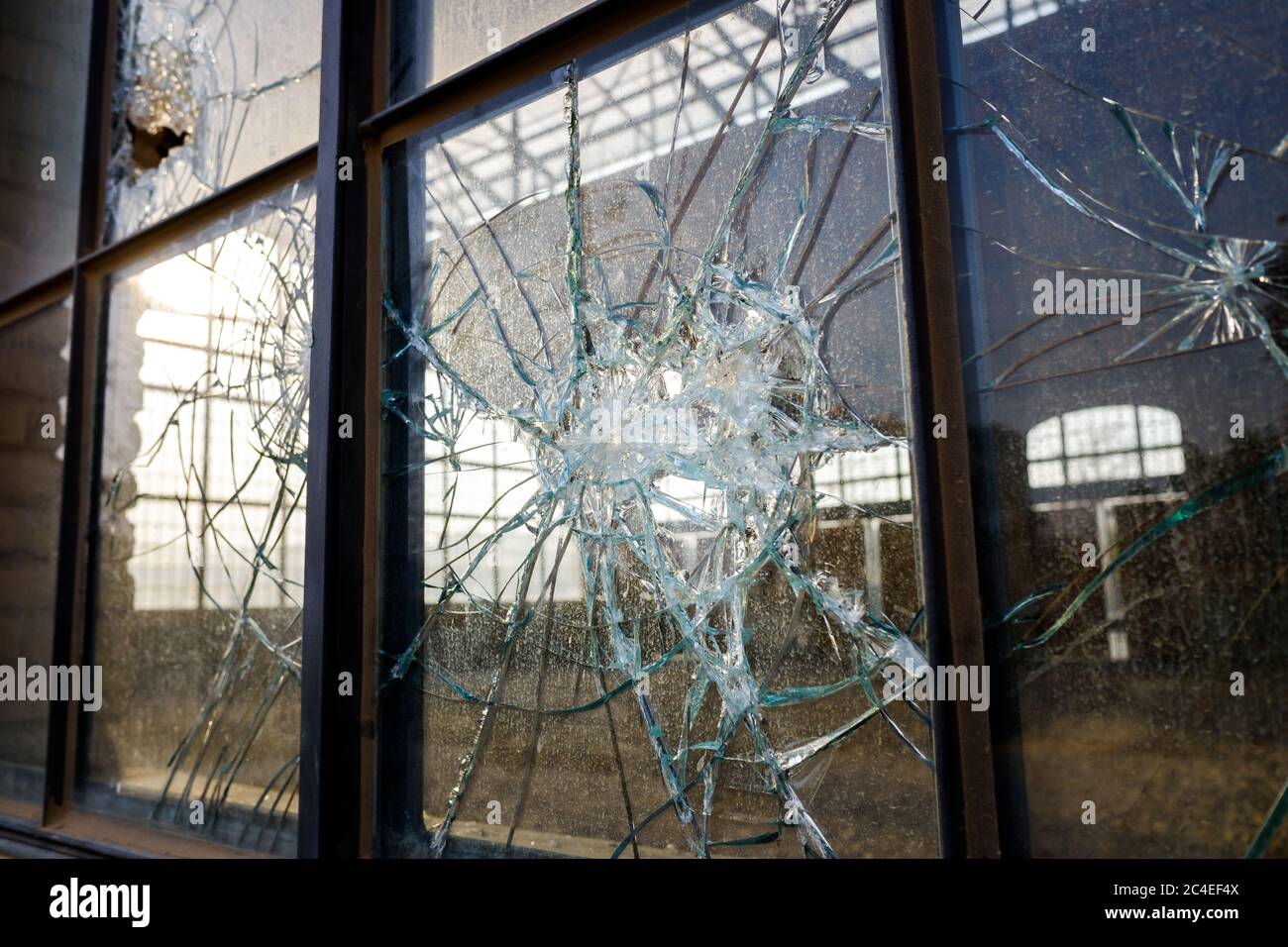 Thick broken glass of a window in an abandoned industrial zone Stock ...