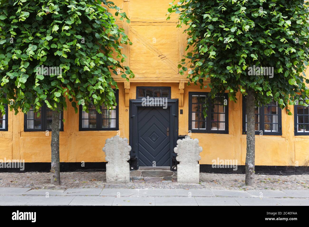 Traditional yellow painted half timbered house in the old town, Koge ...