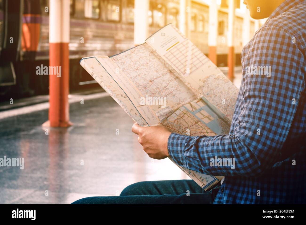 Asian man looking map with finding location for travel Stock Photo - Alamy