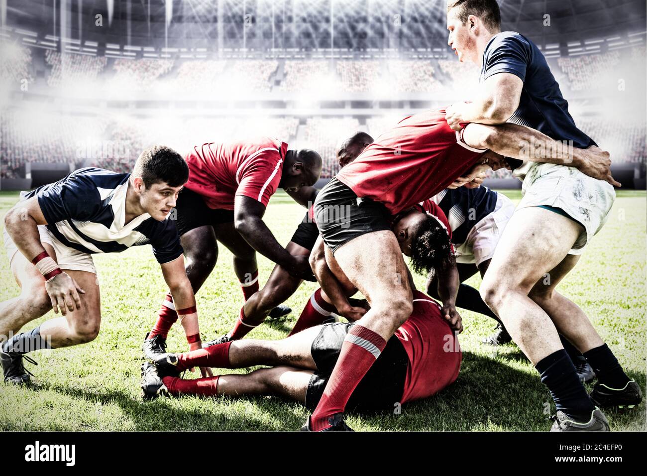 Digital composite image of team of rugby players tackling each other to ...