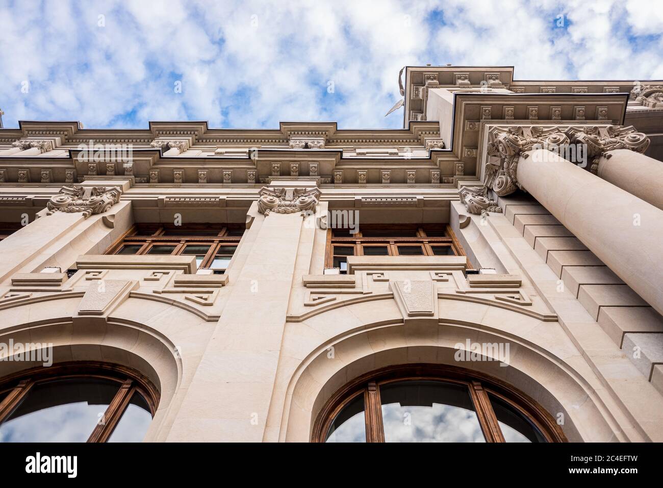 Facade of large institutional building with large columns and windows ...