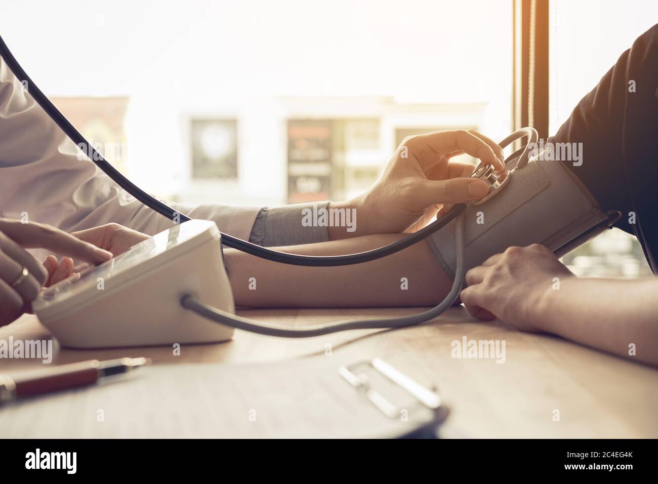 Doctor using stethoscope take a tap on the patient's arm and pressing ...