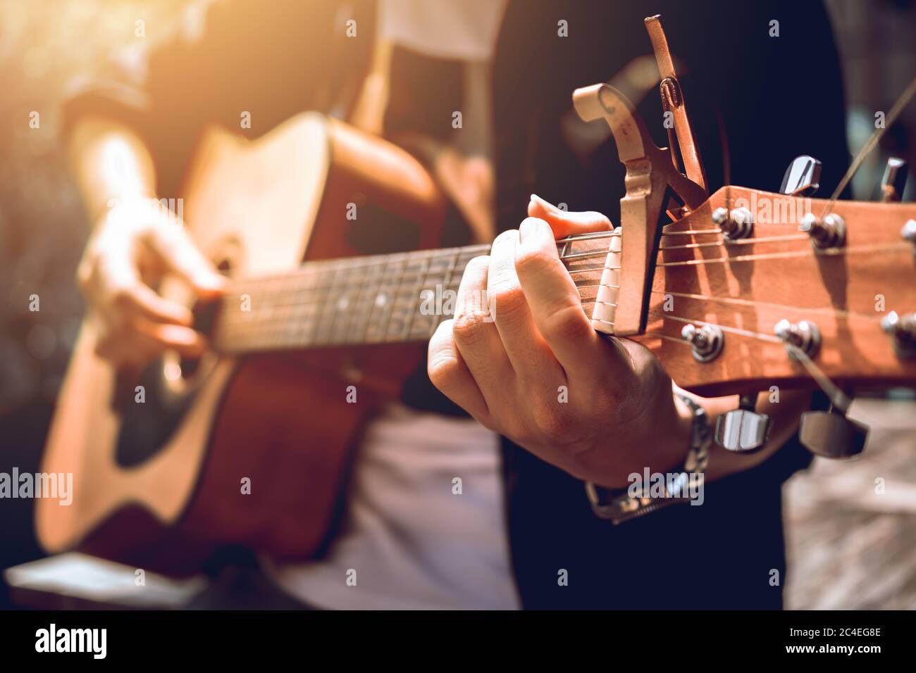 Asian hipster man left hand catch chord and playing music Stock Photo ...