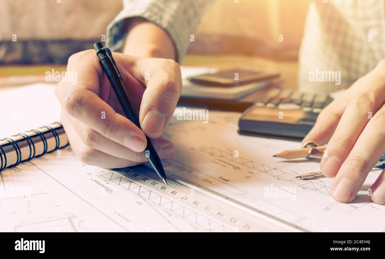 Reviewing blueprints at table hi-res stock photography and images - Alamy