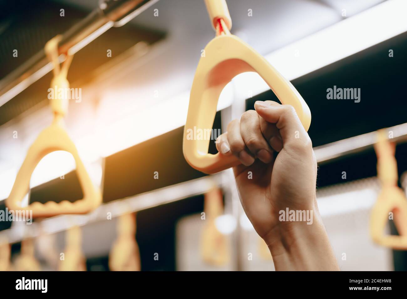 Young passenger woman hand holding handrail in subway Stock Photo - Alamy