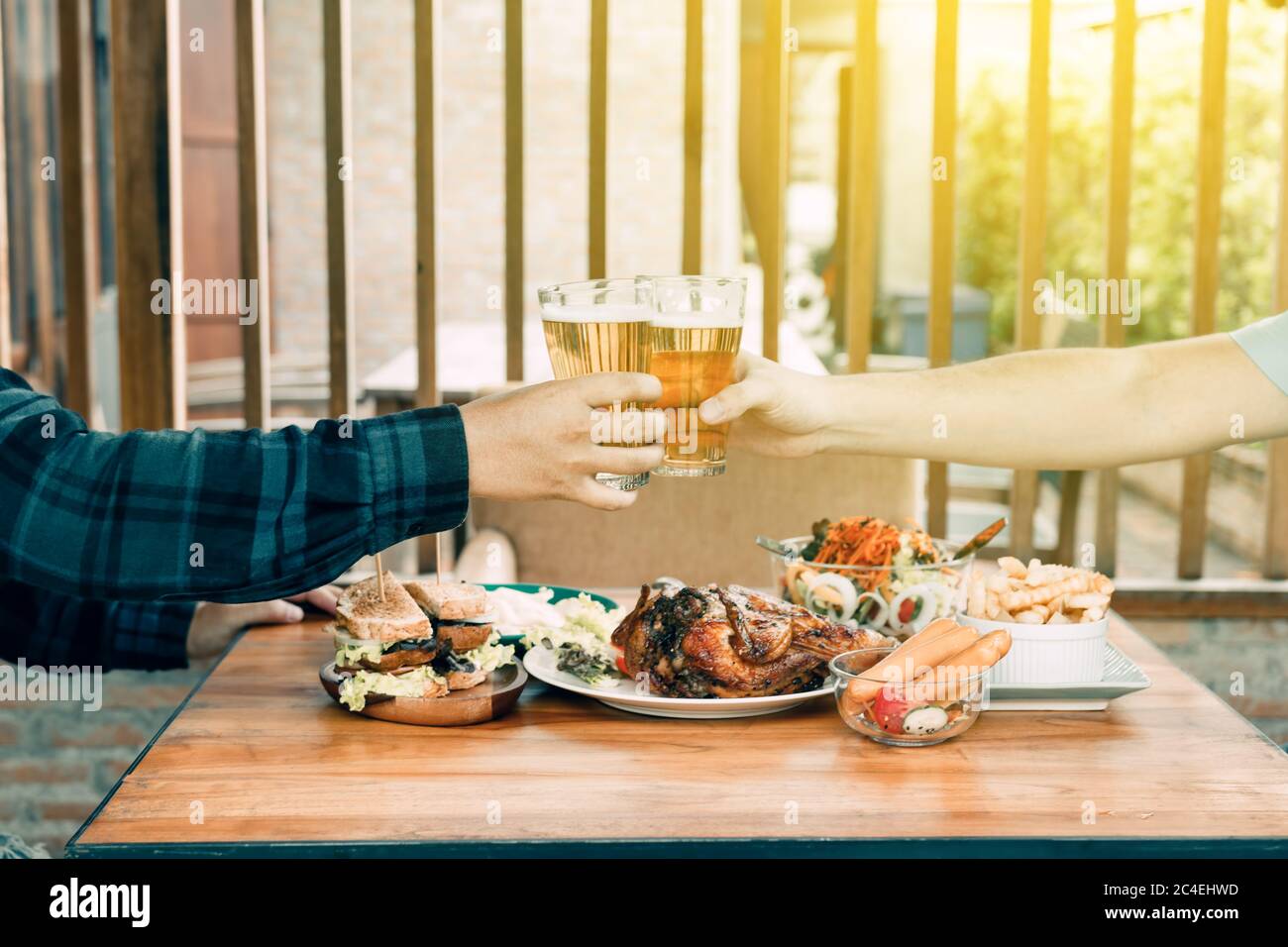 Two people drinking beer at restaurant Stock Photo - Alamy