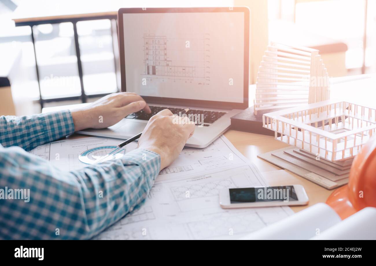 Architect sitting in modern office using computer working project and ...