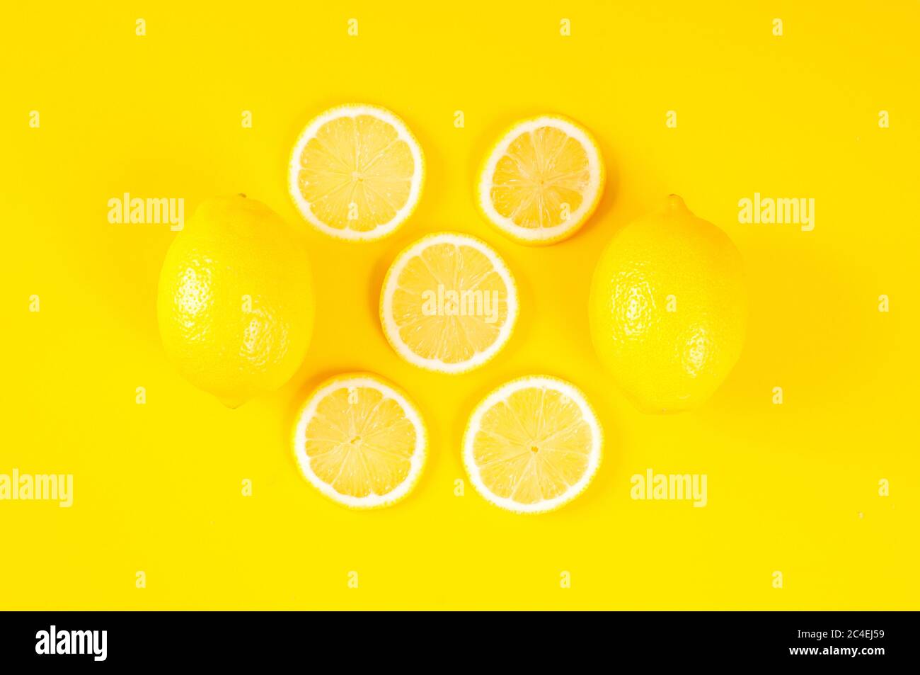 Lemons on bright yellow background. Lemon background concept, flat lay ...