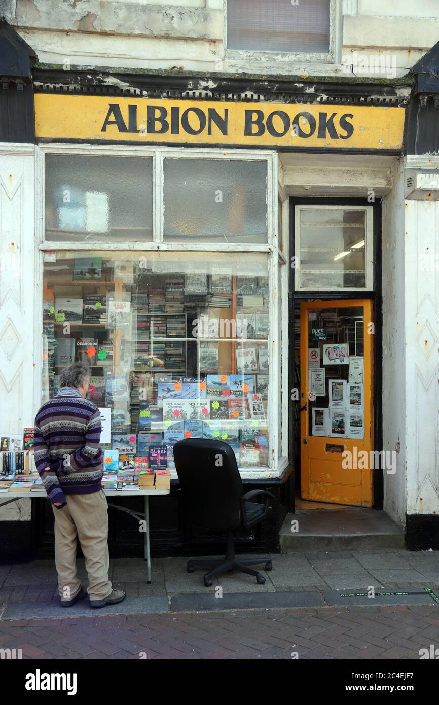 Man looking in Old Bookshop with bay window Stock Photo - Alamy