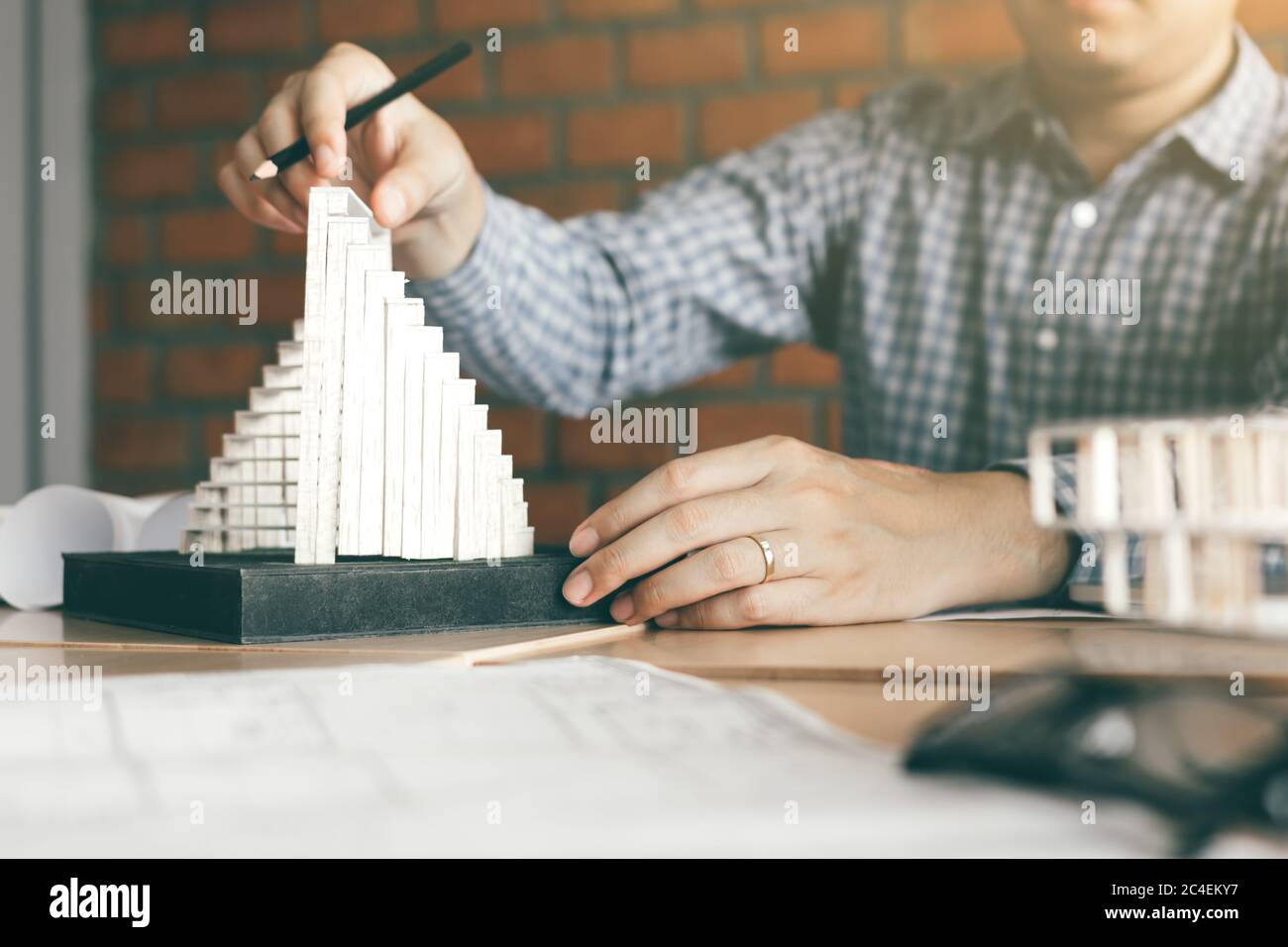 Male engineer using catch modern model in his office. Testing hardness ...