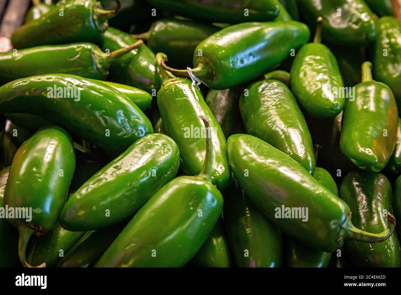 A full frame photograph of green chilli peppers for sale on a market ...