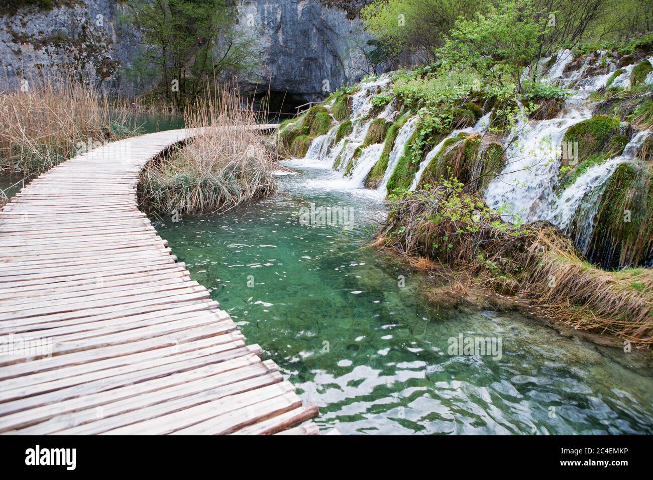 Wooden tourist pathway passing through waterfalls in Plitvice Lakes ...