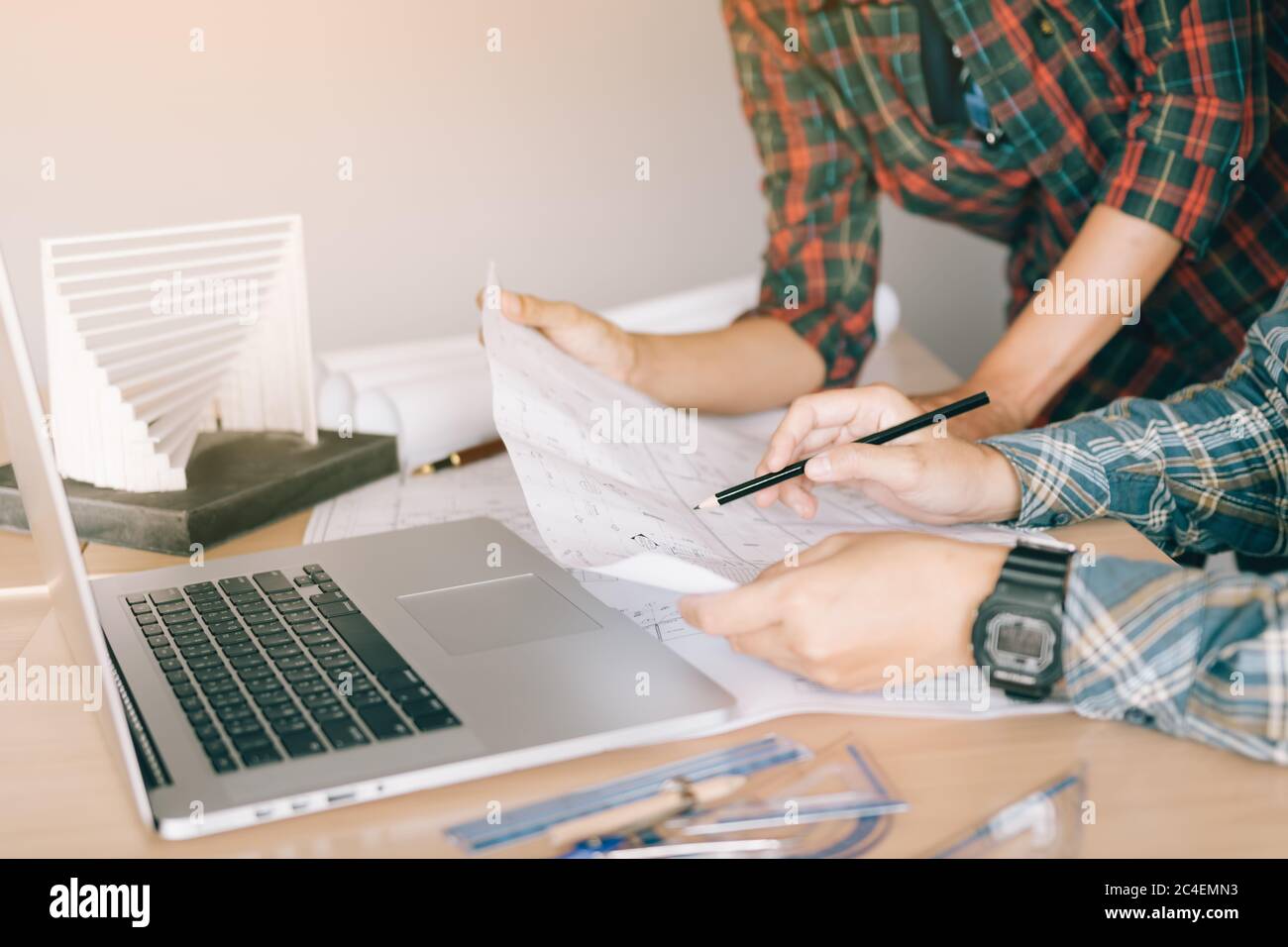 Two engineering man working at office room and discussing together with ...