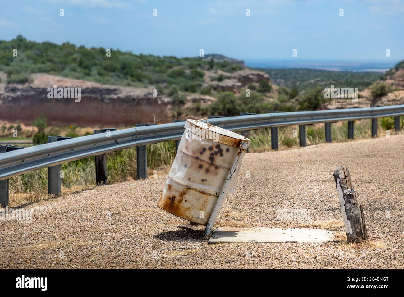 Rusty garbage can on a parking lot in Texas Stock Photo - Alamy