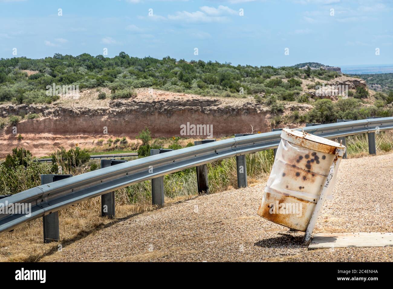 Rusty garbage can on a parking lot in Texas Stock Photo - Alamy