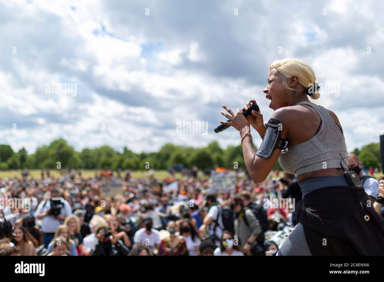 A black woman addresses a crowd during a Black Lives Matter ...
