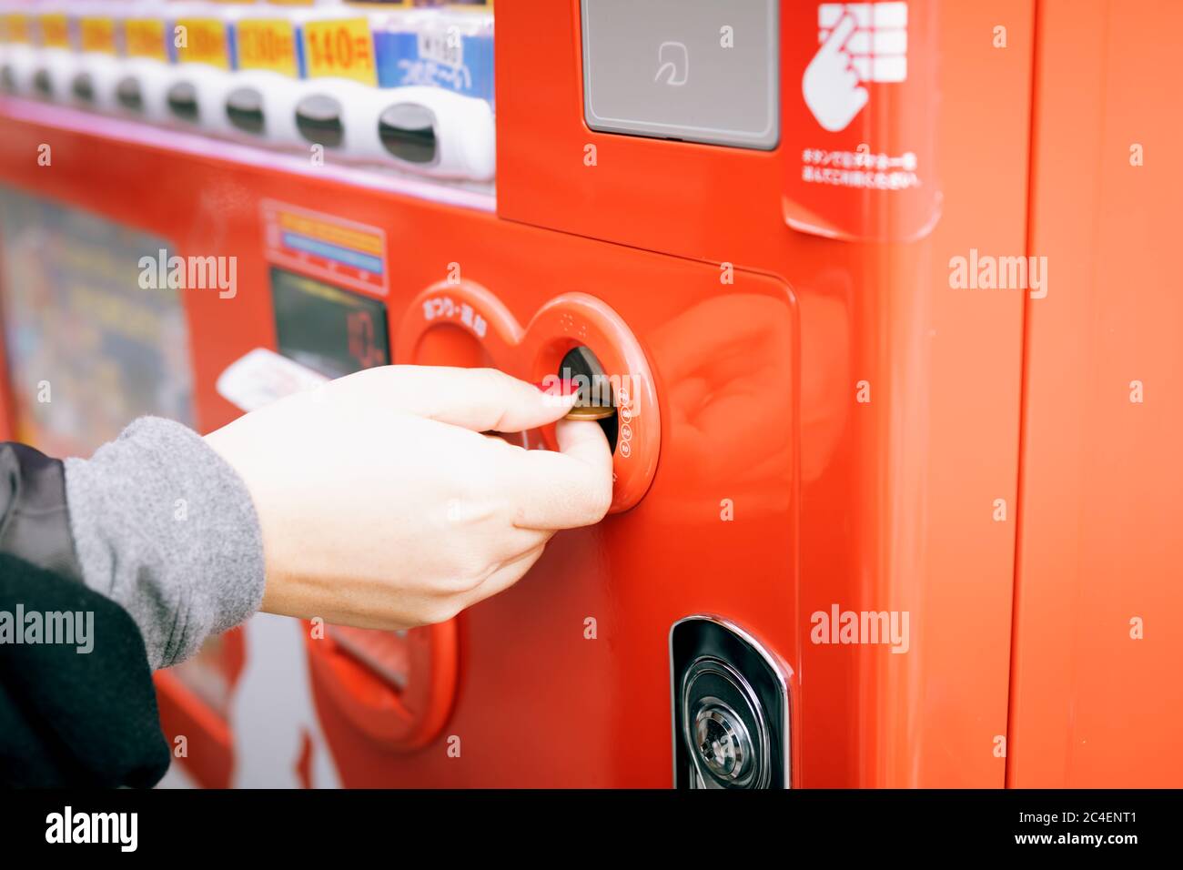 Close up of woman hand inserting coin in vending machine Stock Photo ...