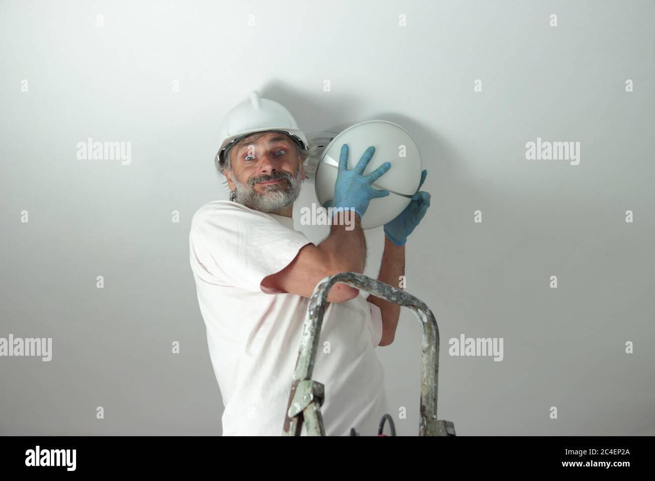Man installing bulb lamp hi-res stock photography and images - Alamy
