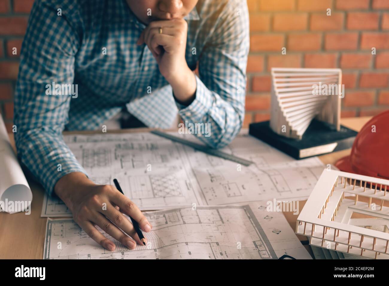Stress architect man looking blueprint on desk about problem structure ...