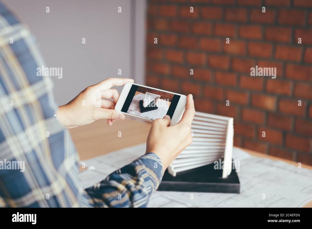 Architect man holding smartphone taking a photo of an architecture ...