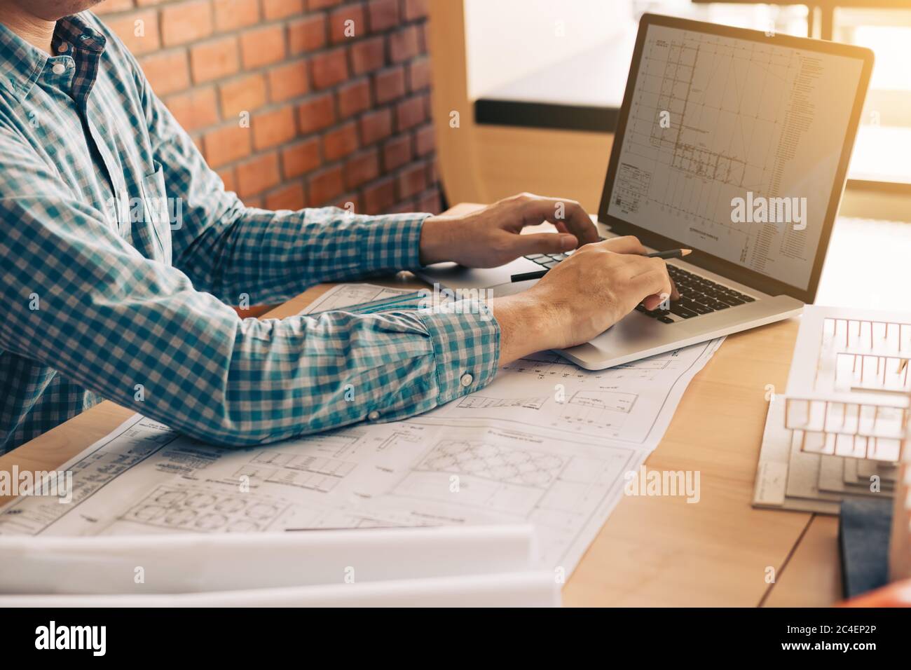 Architect sitting in modern office using computer working project and ...