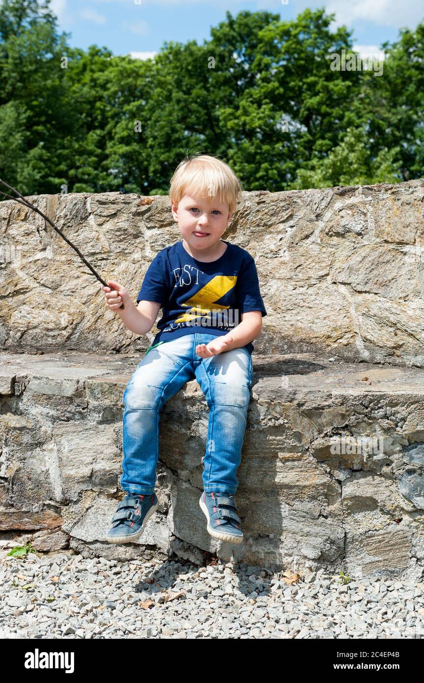 Boy sitting on wall hi-res stock photography and images - Alamy