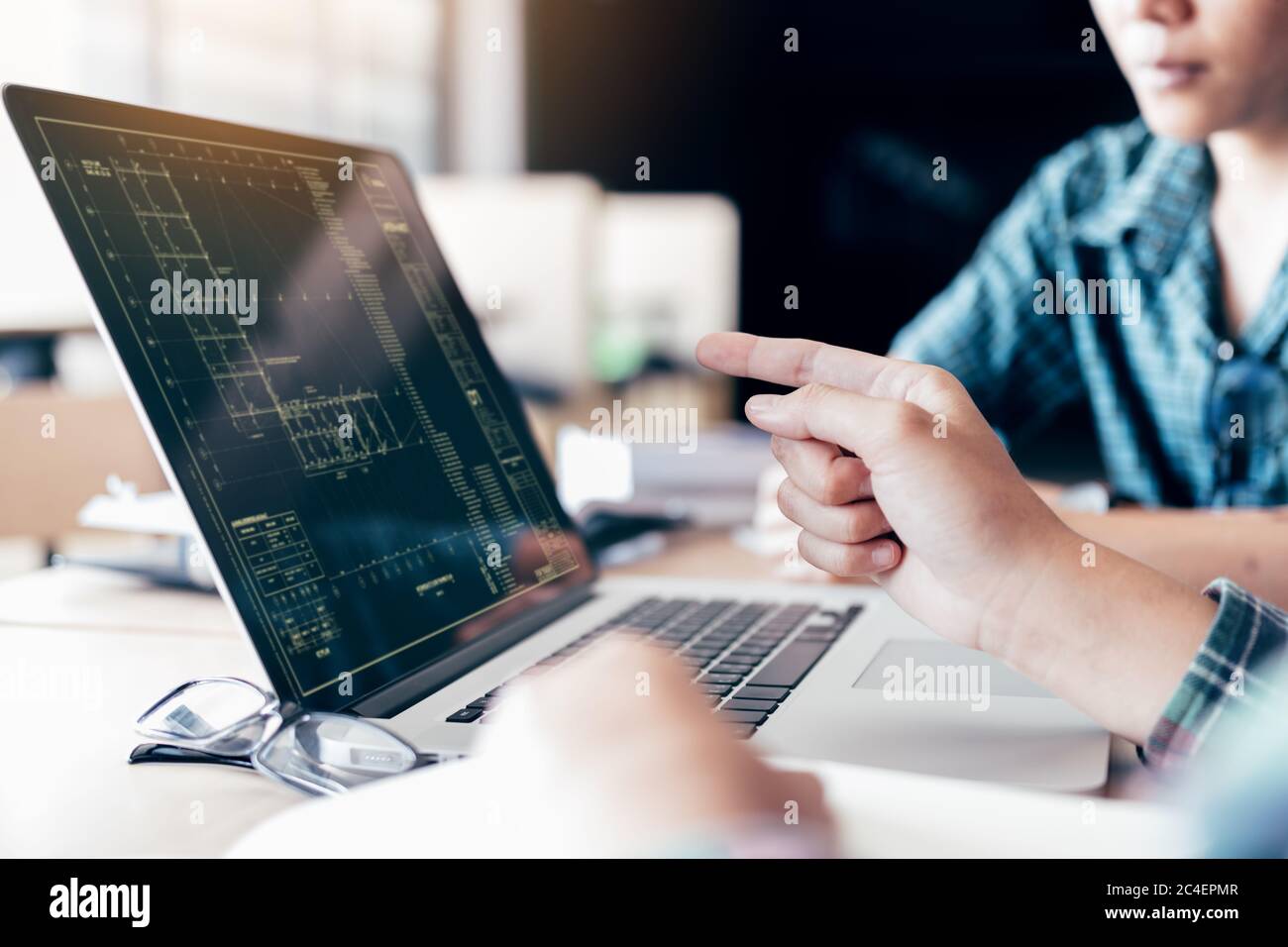 Teenagers develop programming with blueprint code in laptop monitor ...