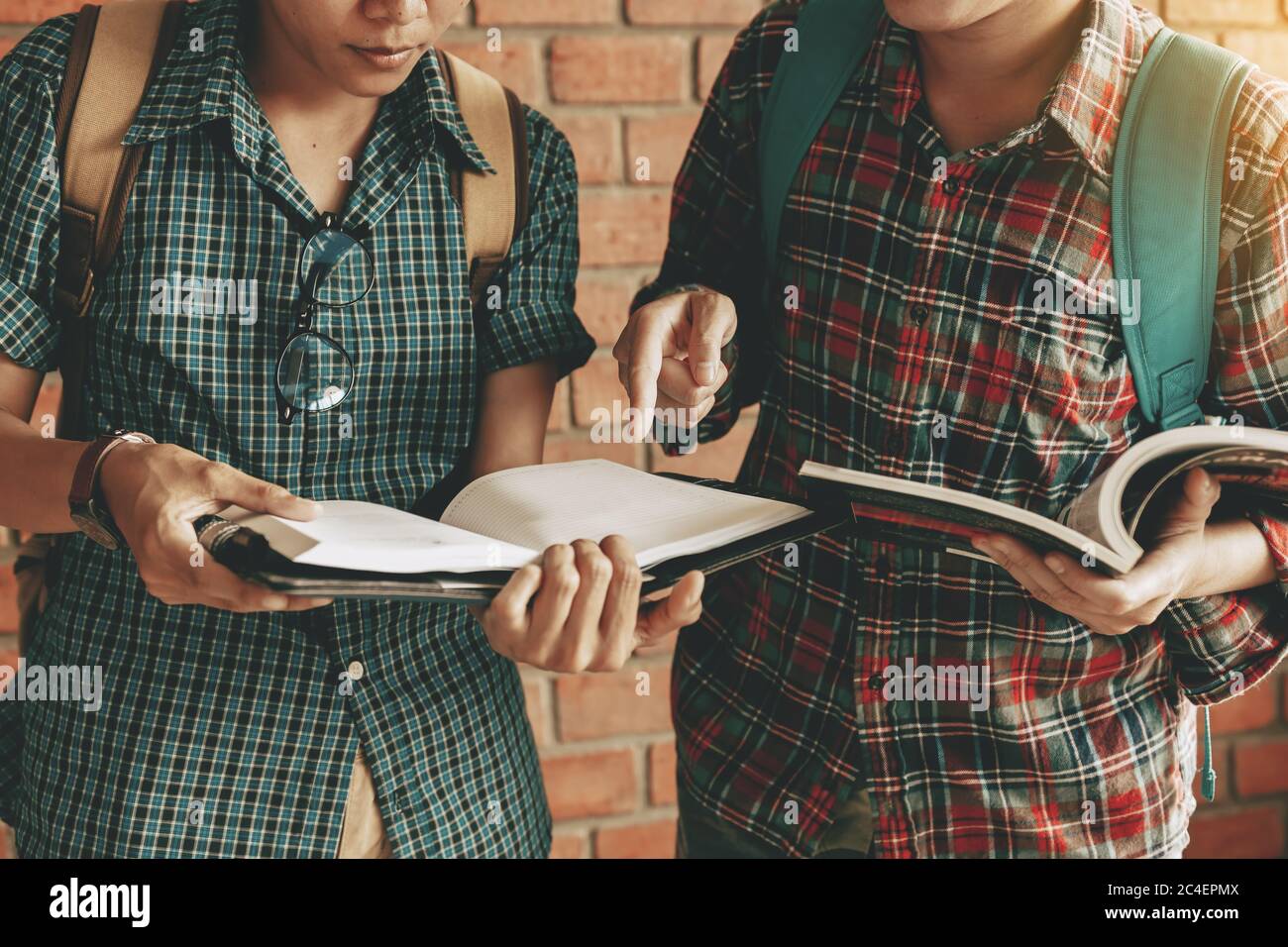 Two student reading book together in library room at school Stock Photo ...