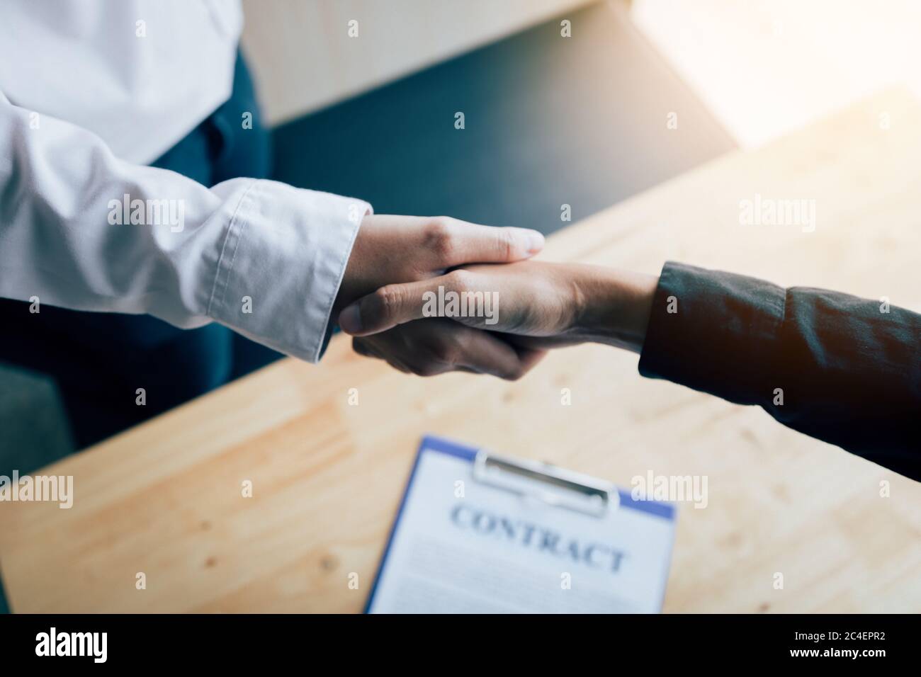 Two people shaking hands with making a contract in the office Stock ...