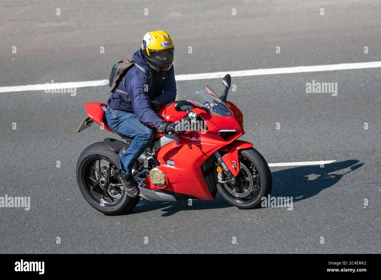 Red Ducati Panigale V4; Motorbike rider; two wheeled transport ...