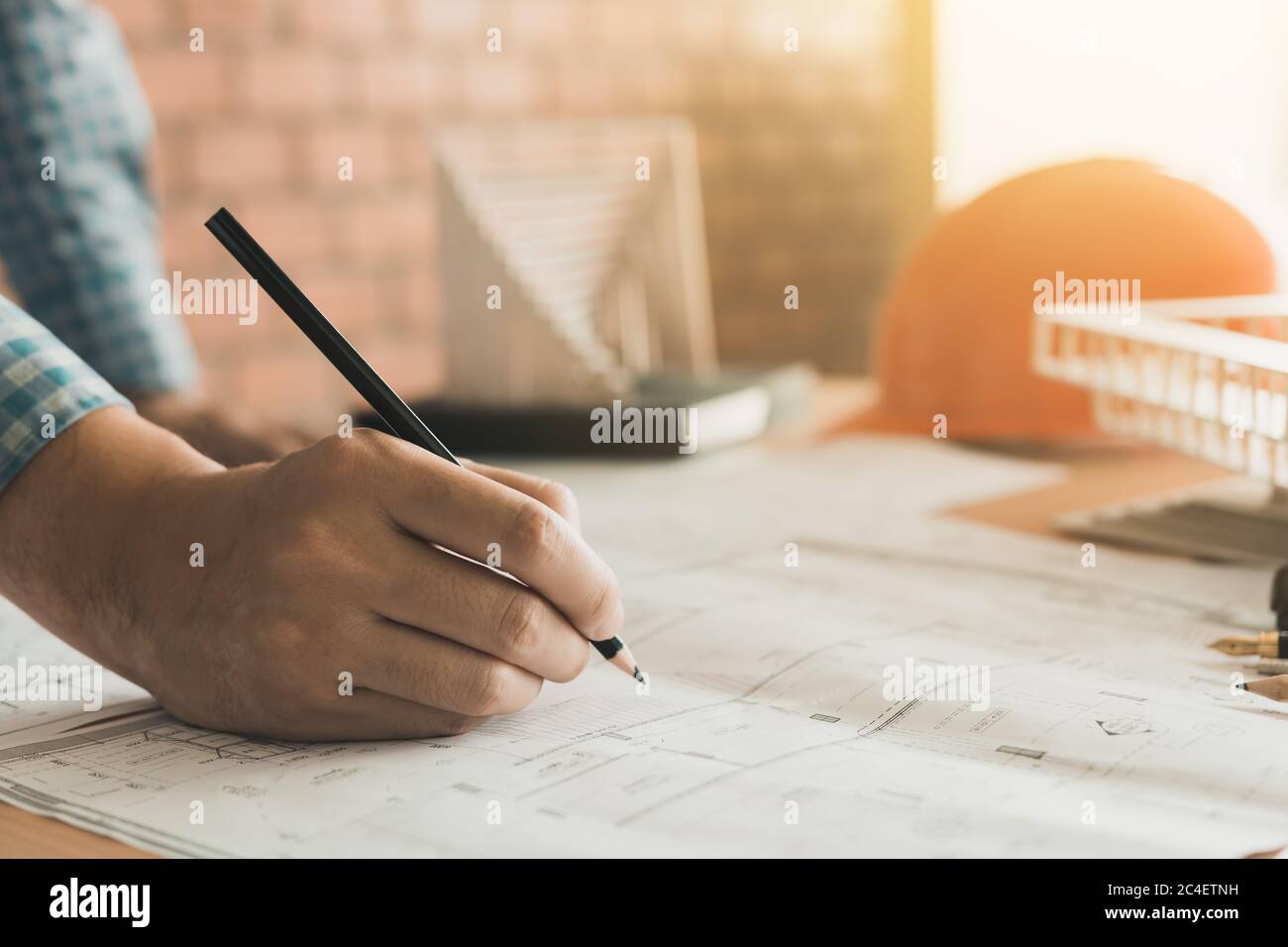 Hand of young engineering man drawing on blueprint Stock Photo - Alamy