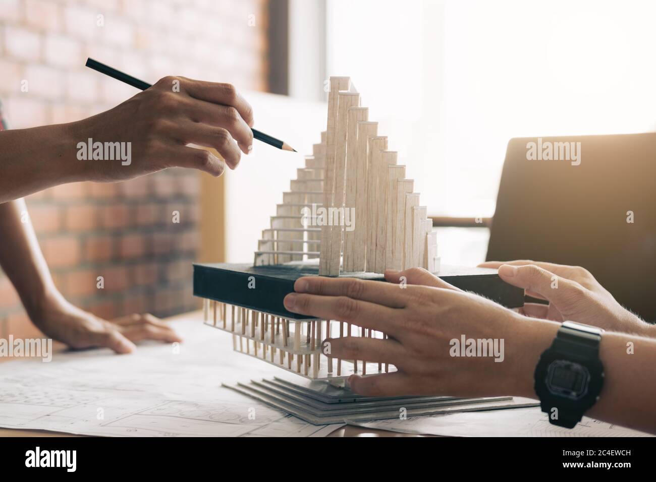 Architect reviewing architectural model in the office Stock Photo - Alamy