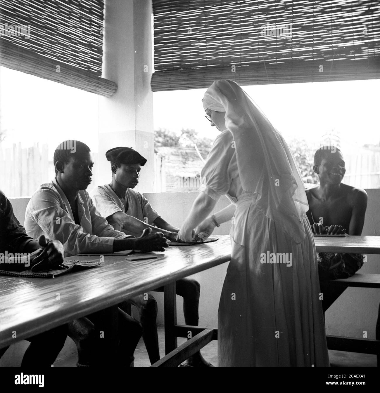 Nun Missionary checking the hands of young men in the Ivory Coast 1963 ...