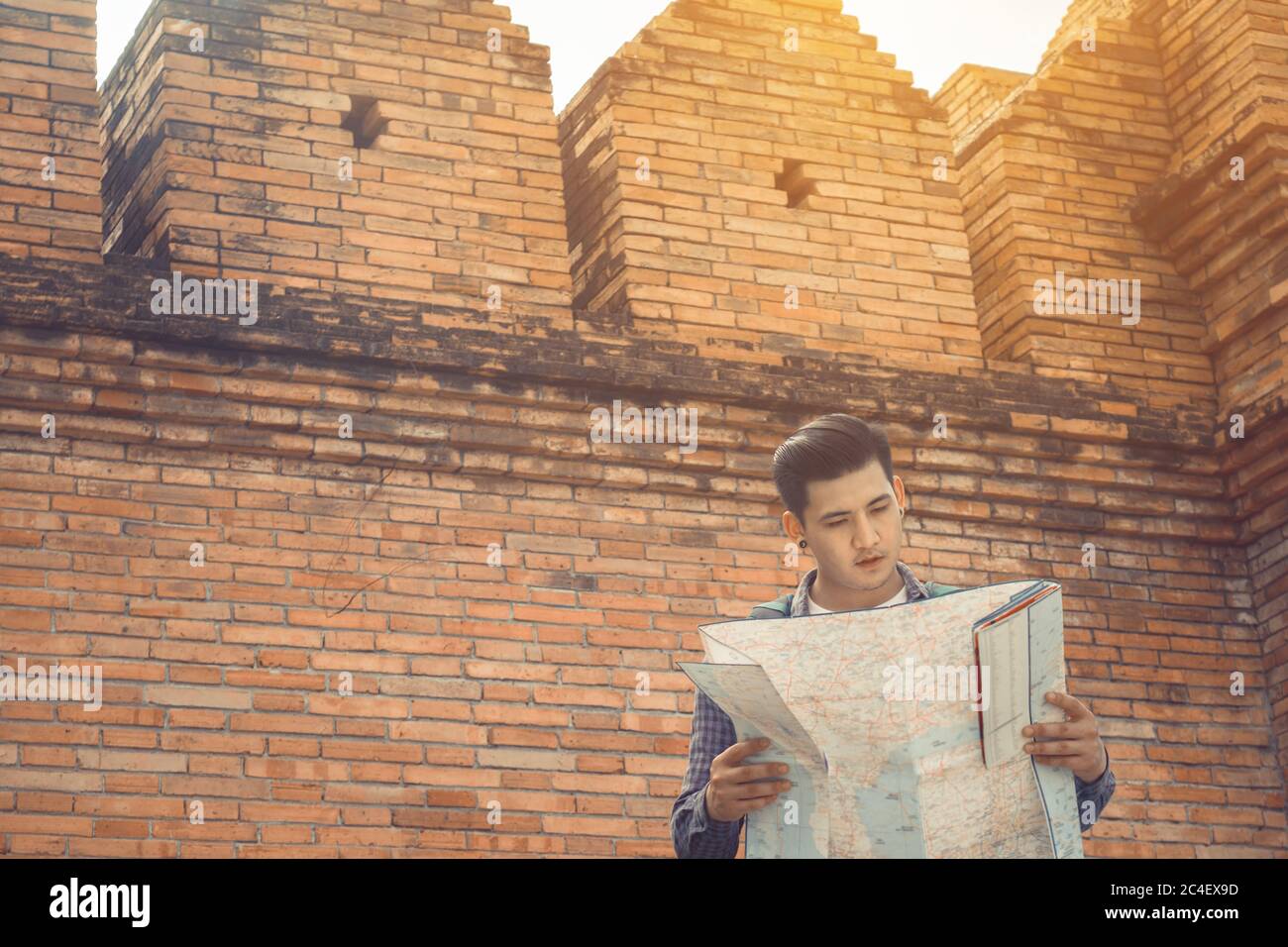 Handsome man holding map paper with finding location for travel Stock ...