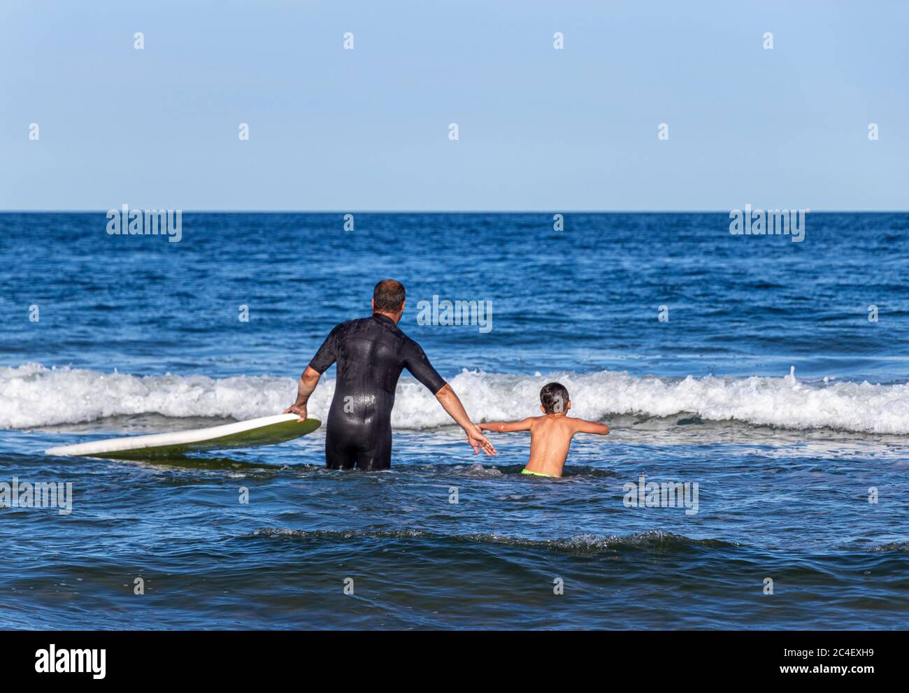 Father and son surfing lessons Stock Photo - Alamy