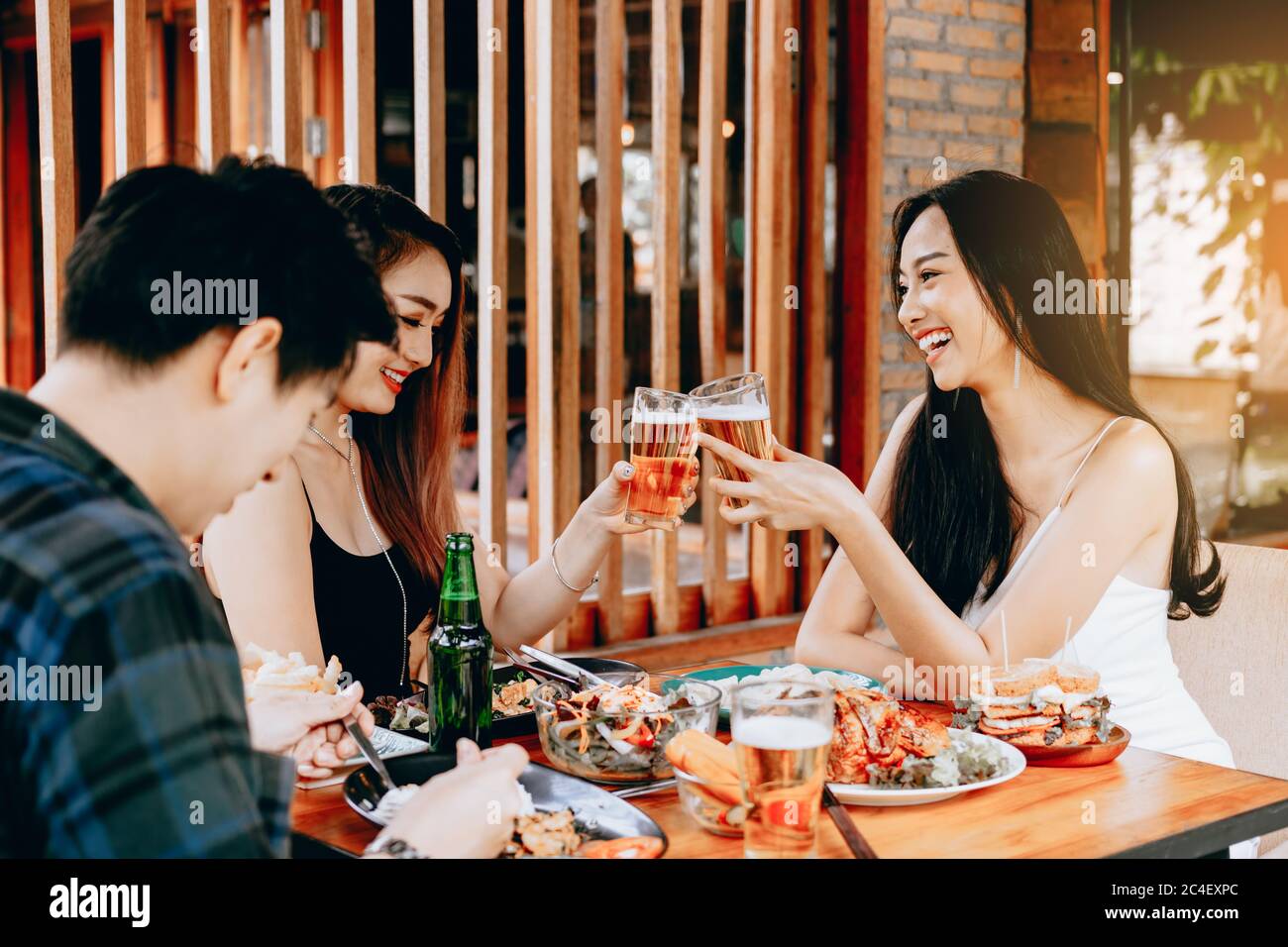 Young asian people having fun at drinking with cheering with beer at ...