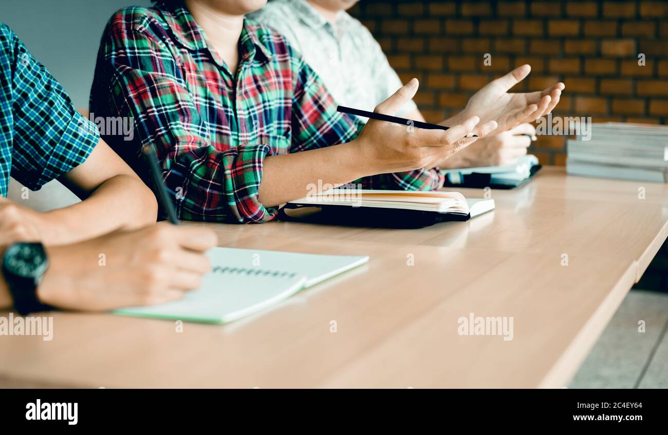 Group of asian students showing hands talking question with teacher in ...
