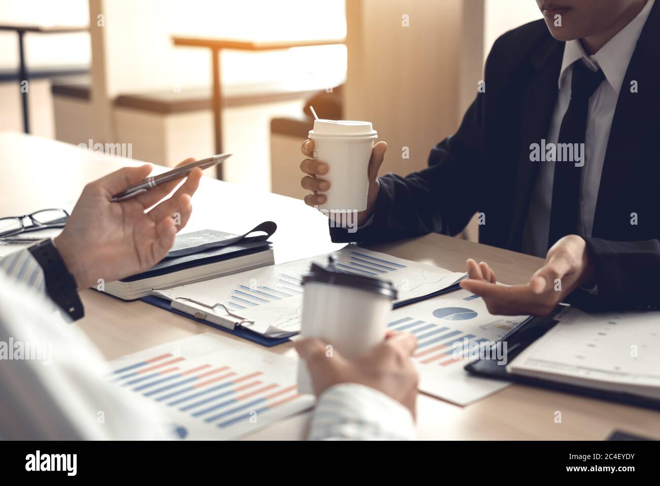 Business people discussion financial documents and important ...