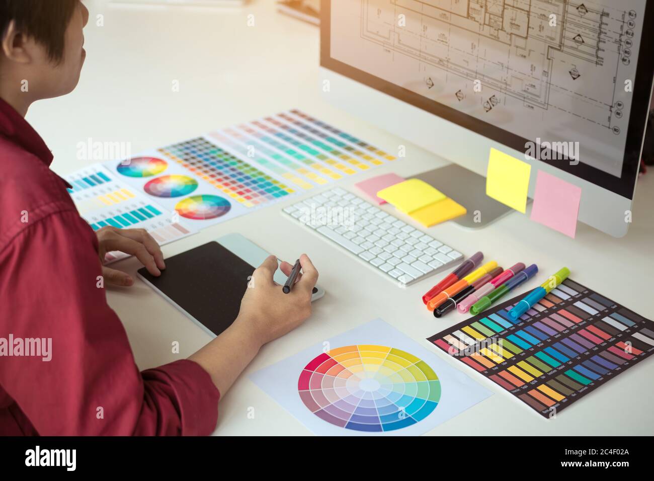 Digital artist sketching blueprint and using computer with digital ...