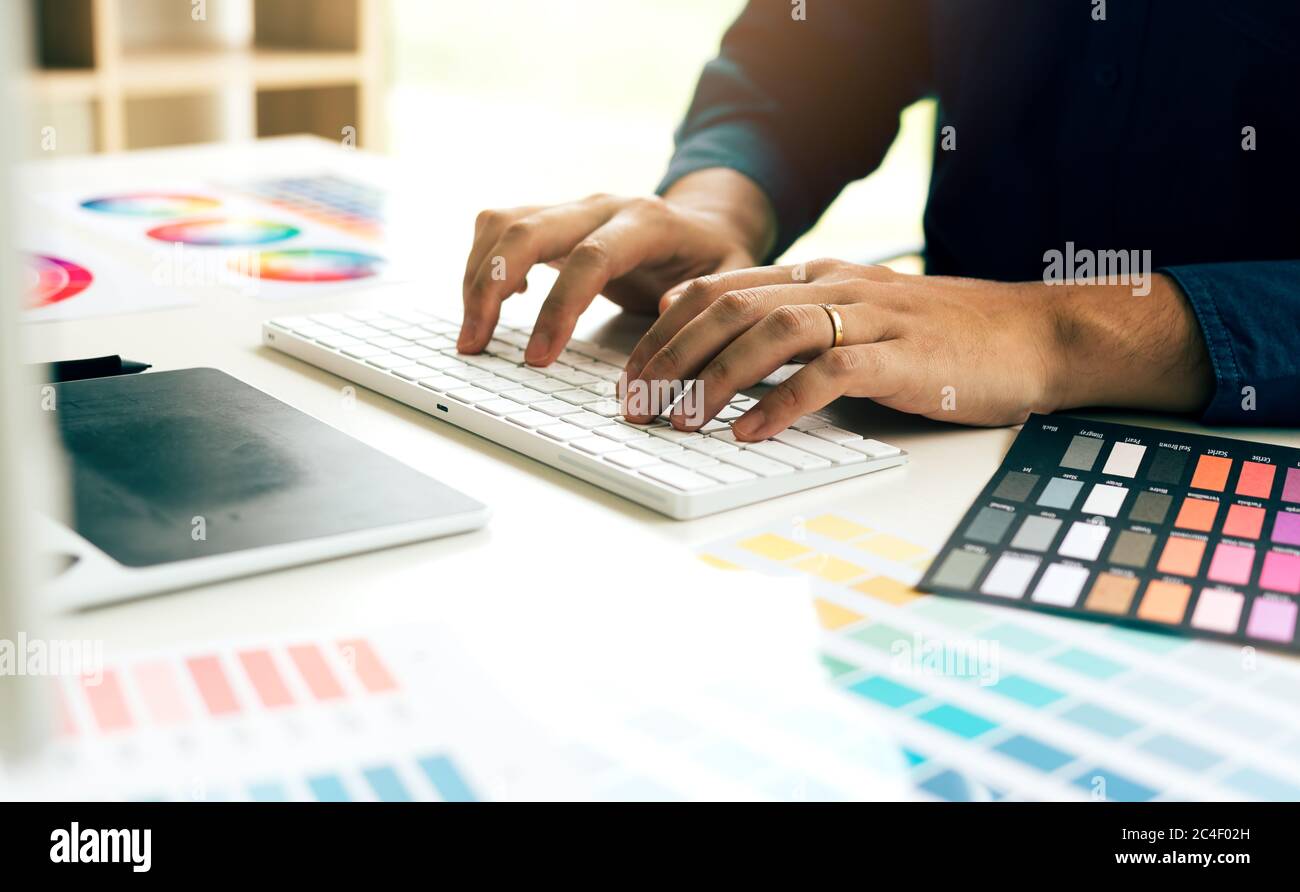 Graphic designer typing keyboard on desk in modern office Stock Photo ...