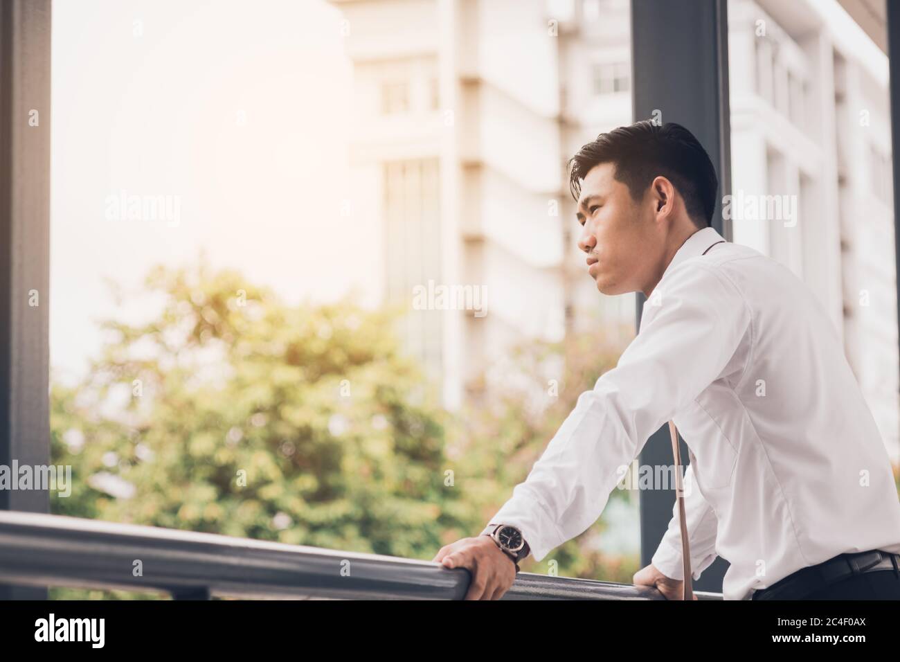 Frustrated businessman standing outside corporate hi-res stock ...