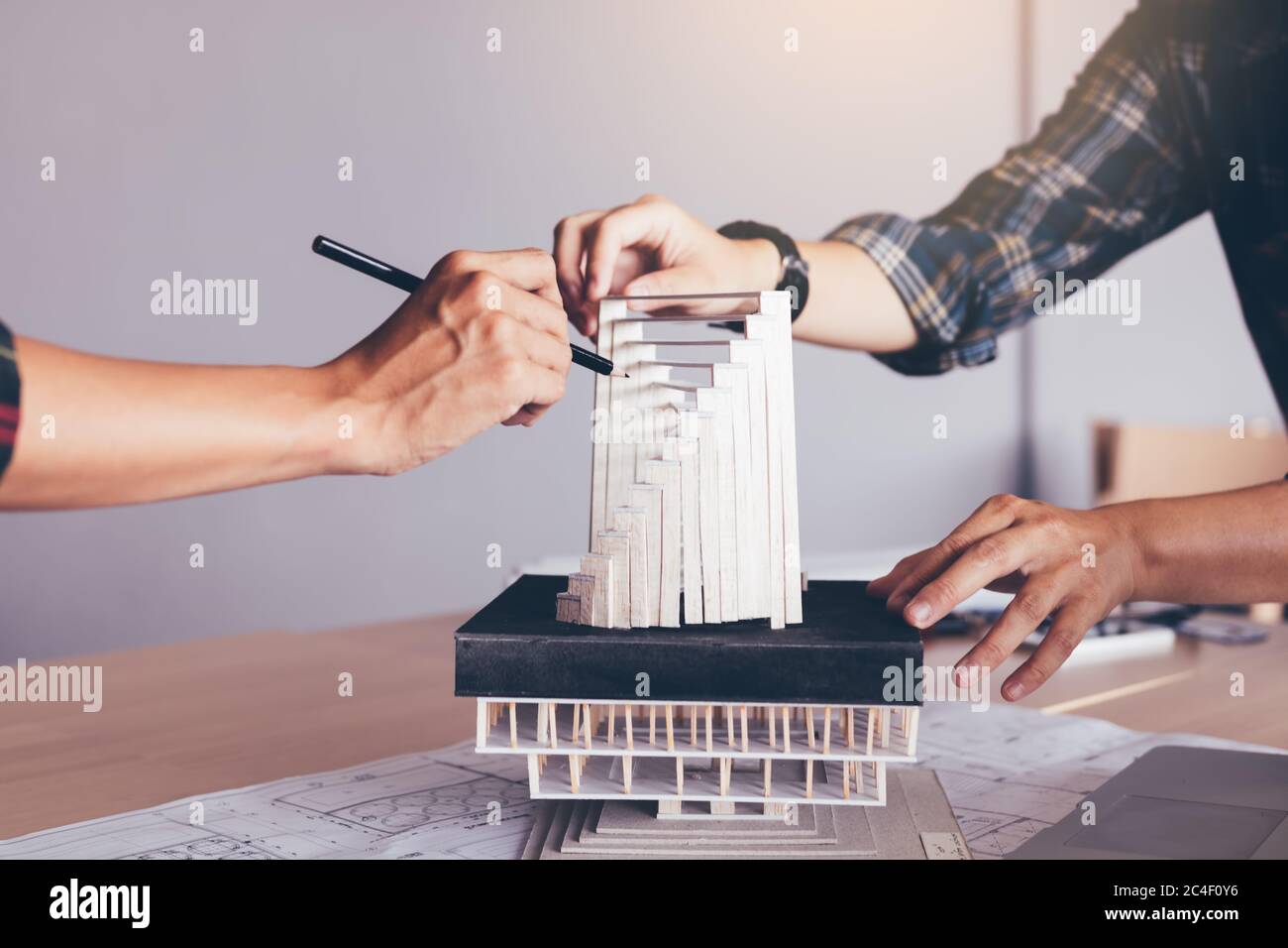 Architect reviewing architectural model in the office Stock Photo - Alamy