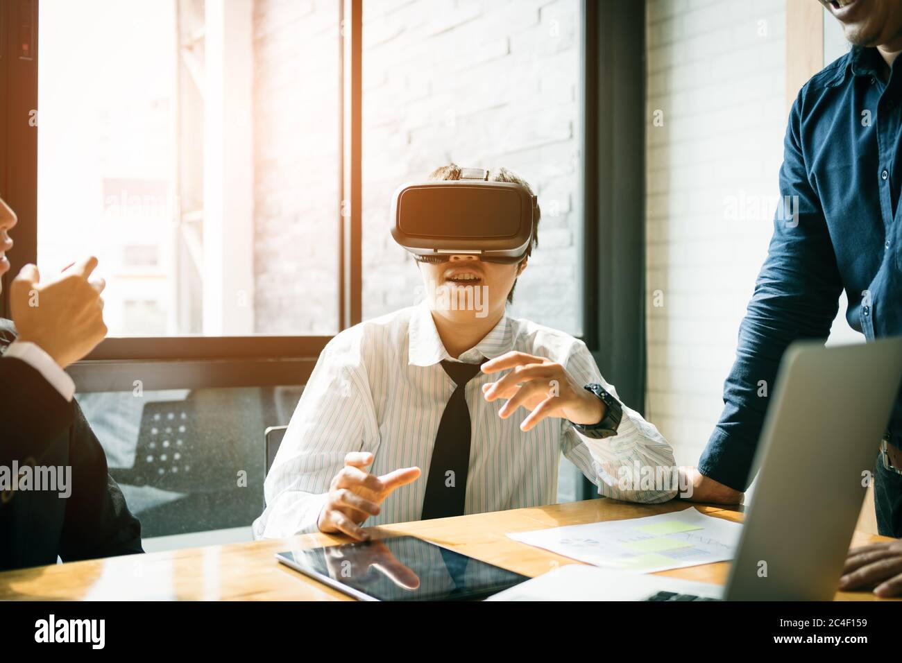 Young business people testing virtual reality VR headset technology ...