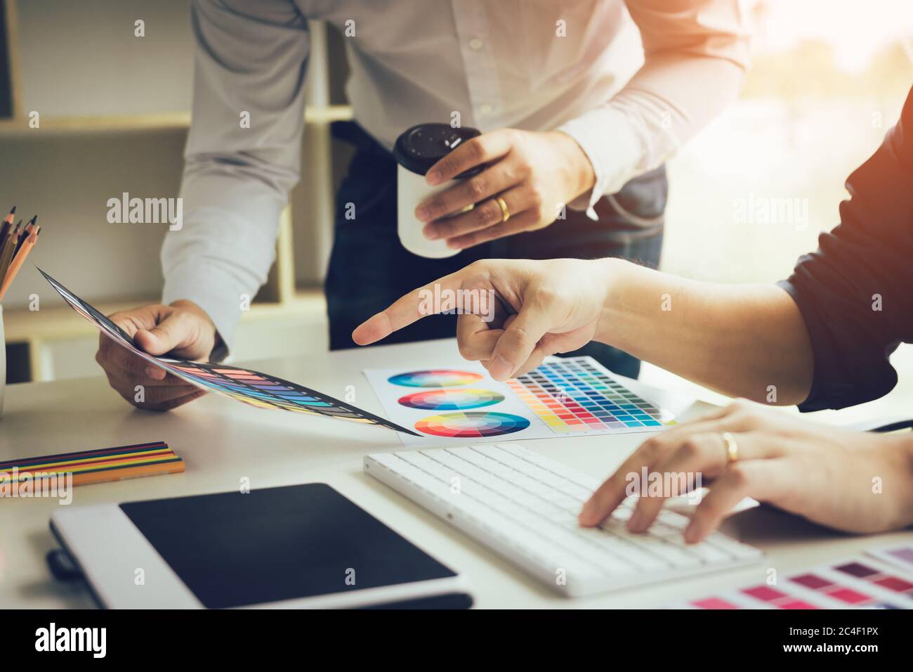 Co-worker working with graphic design in office room together Stock ...