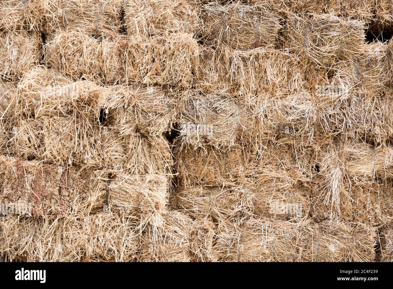 Pressed hay briquettes under the shed. This image may be used as a ...