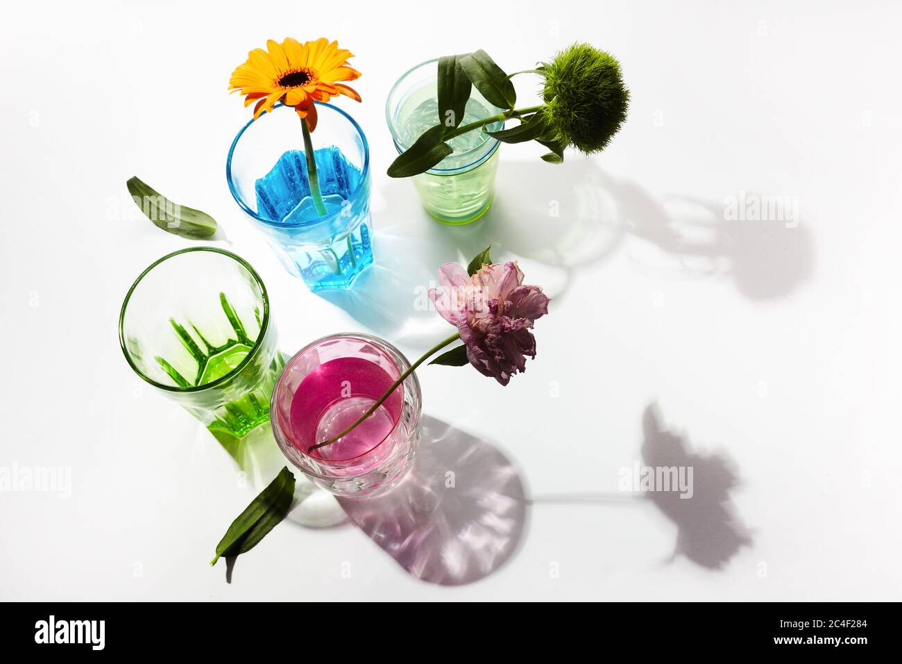 summer still life scene. Crystal glasses with long harsh shadows Stock ...