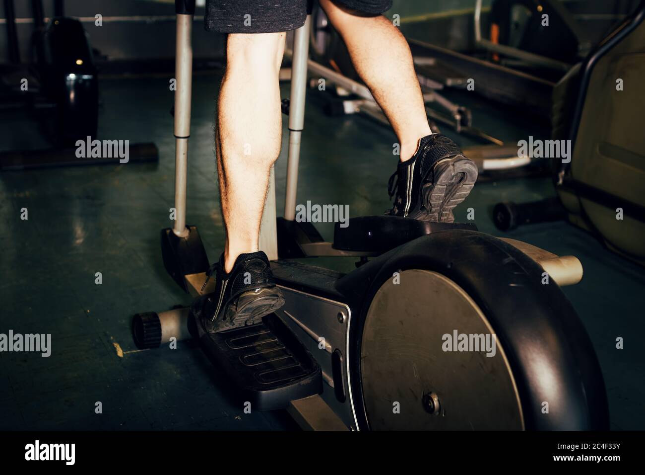 Man running in a gym on a treadmill for exercising Stock Photo - Alamy